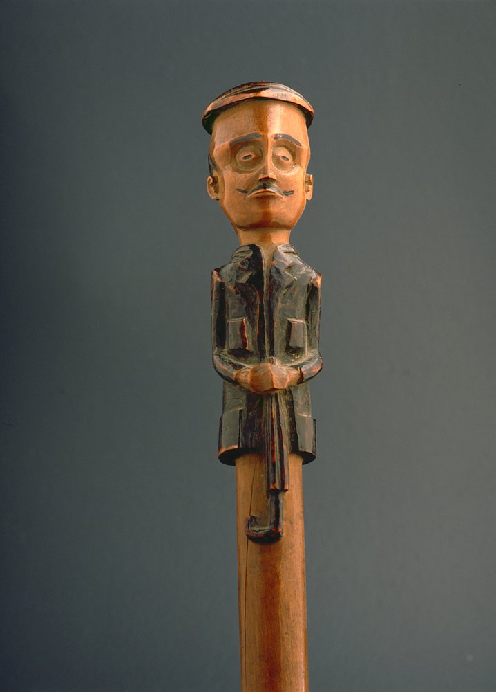 Stick with a Figure of a European Man Wearing a Cap and Holding an ...