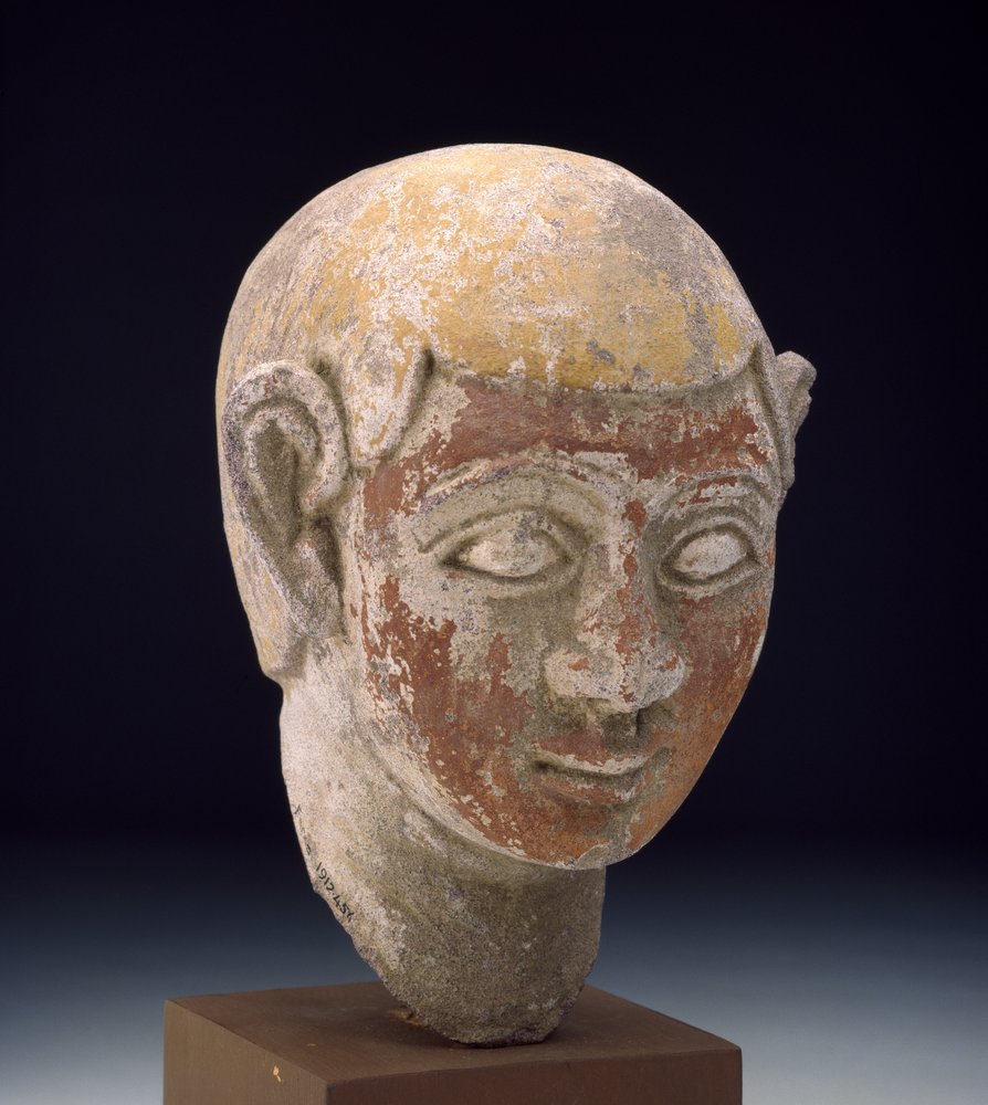 Painted sandstone head of a ba-statue by Egyptian