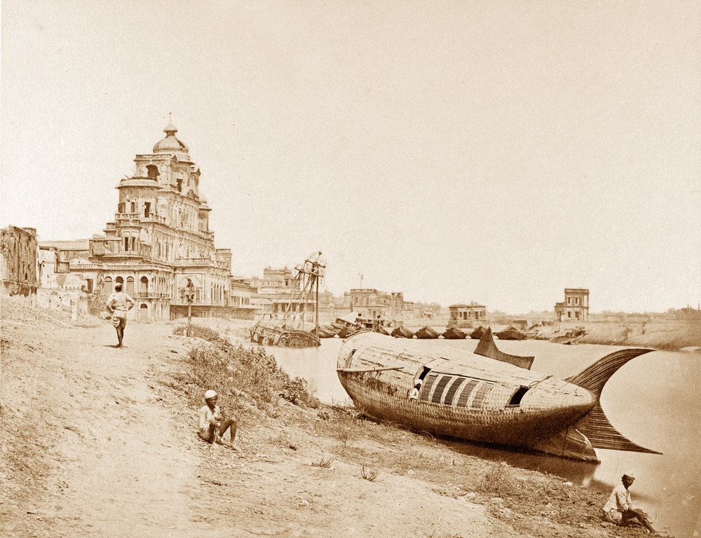 View of the Chattar Manzil Palace with the King's Boat on the River ...