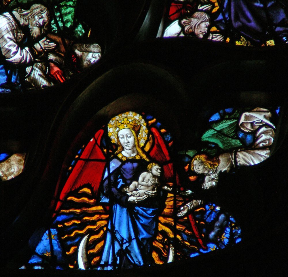 The west rose window depicting a scene from the Book of Revelation ...