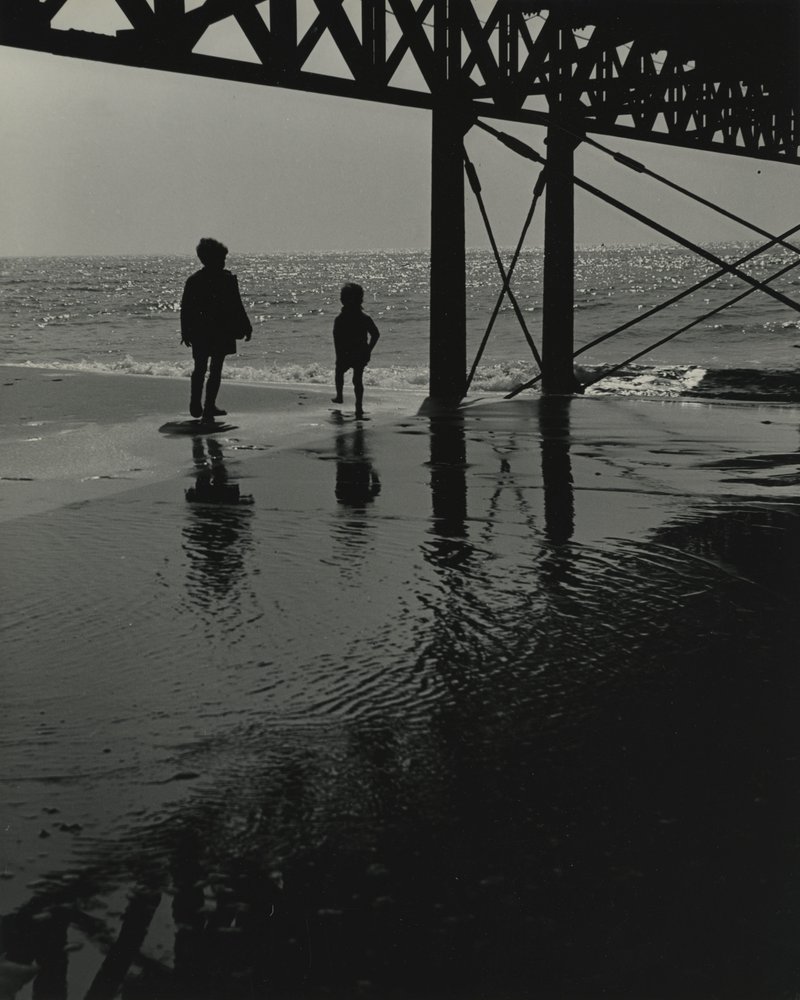 Two kids playing at the beach by Godfrey Macdominic