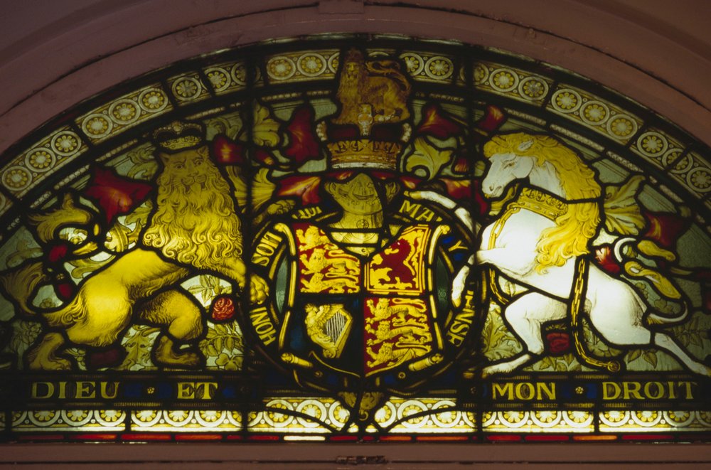 Stained glass window with the royal coat of arms of the United Kingdom ...