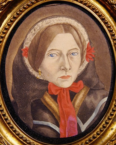 Portrait of a woman with a bonnet and red ribbon
