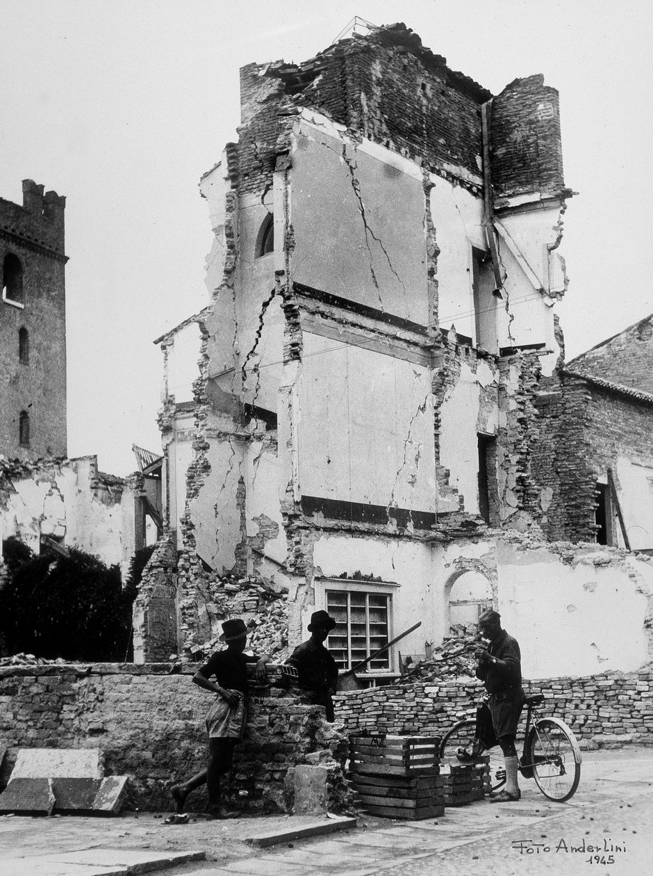 The bombardments of Sermide. Three people in front of a group of ...