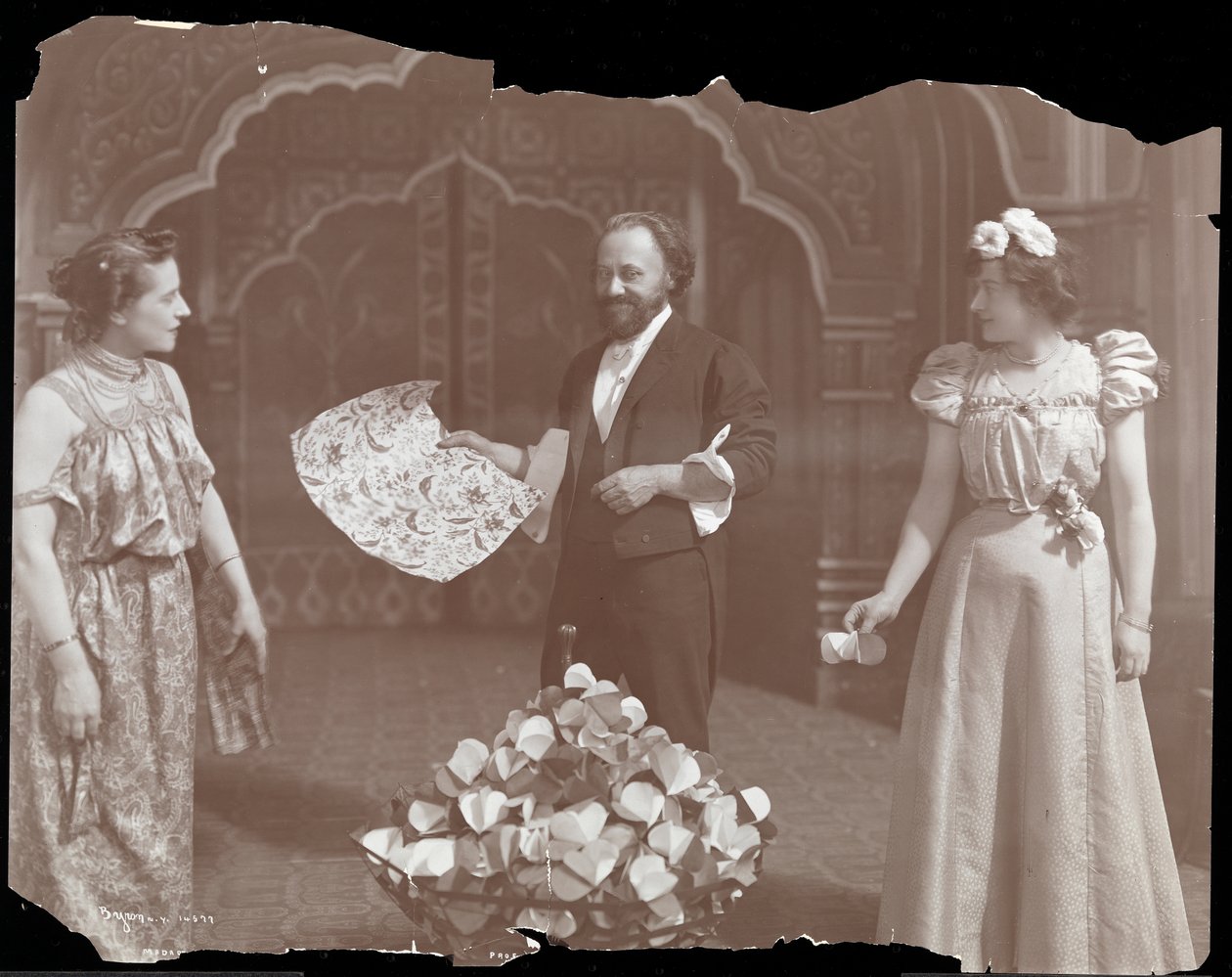 Professor De Kolta on Stage with Two Women by Byron Company