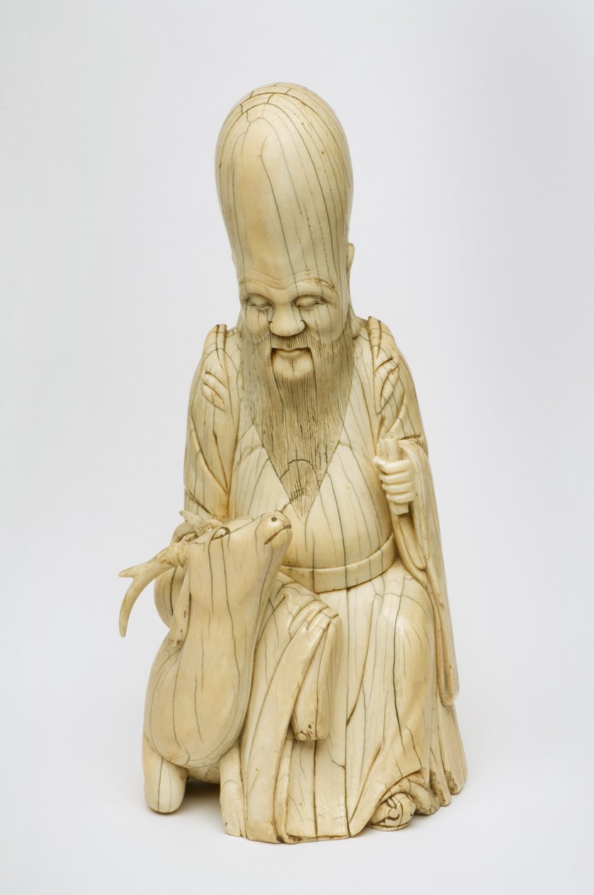 Carved Ivory figure of Shou Xing seated with deer, c.1580-1644