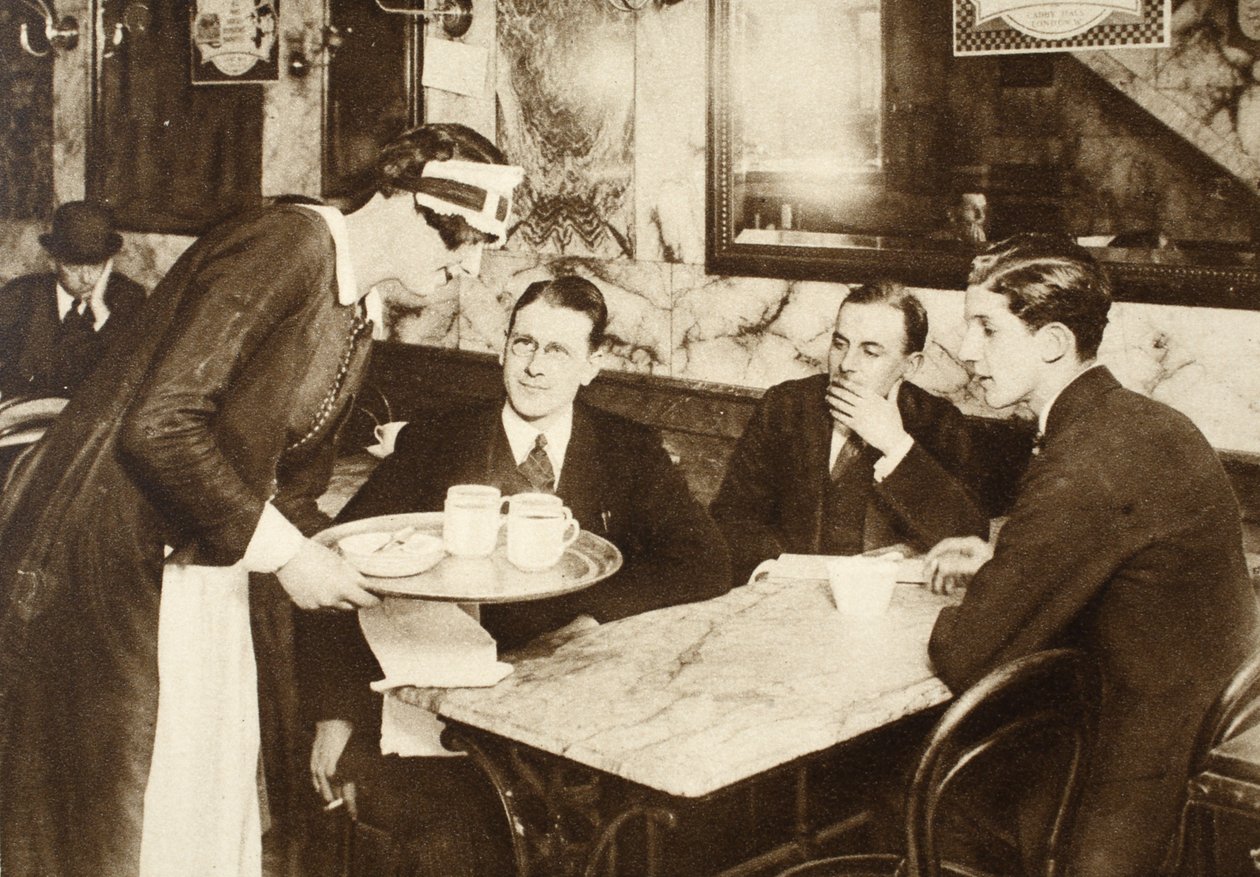 A cafe waitress, wearing the same uniform as a parlour maid, serving ...