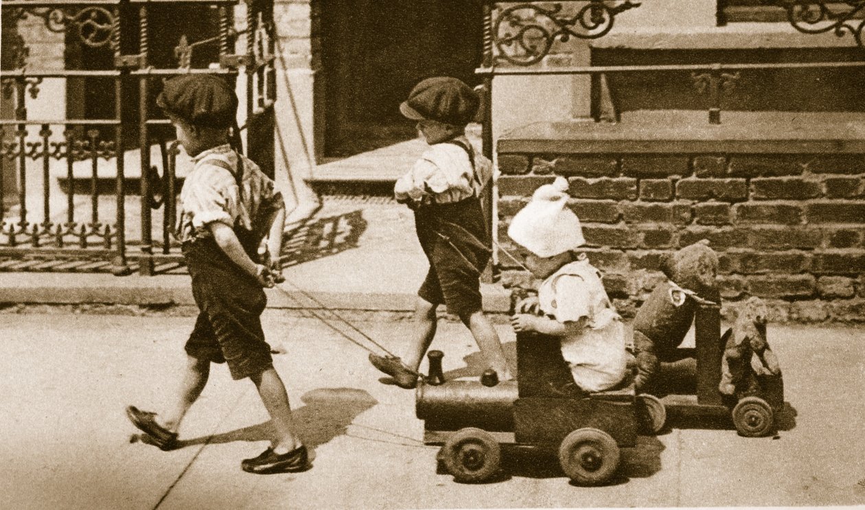 Children play on the street: boys pulling carts