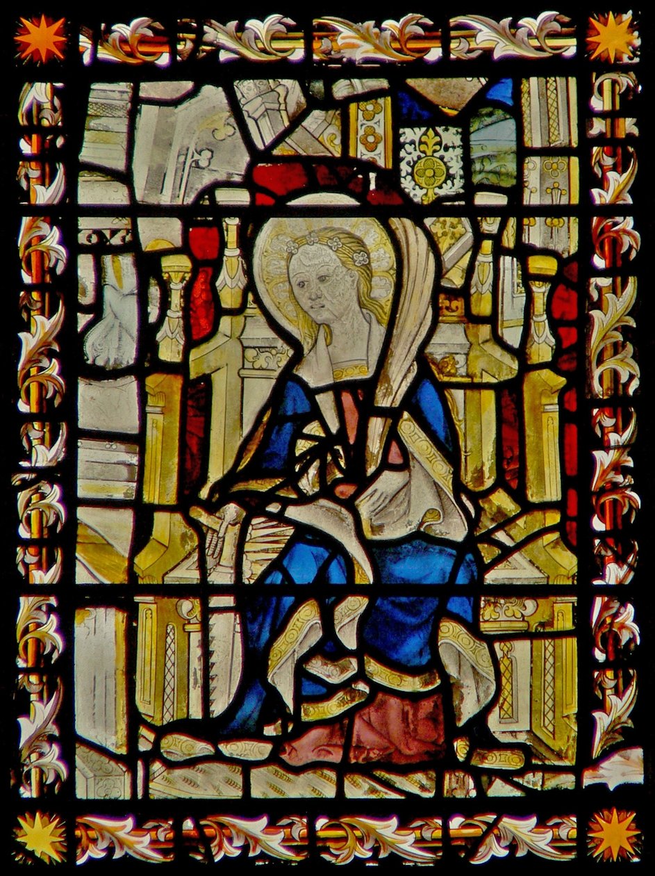The east window depicting St Faith carrying her emblem the saw