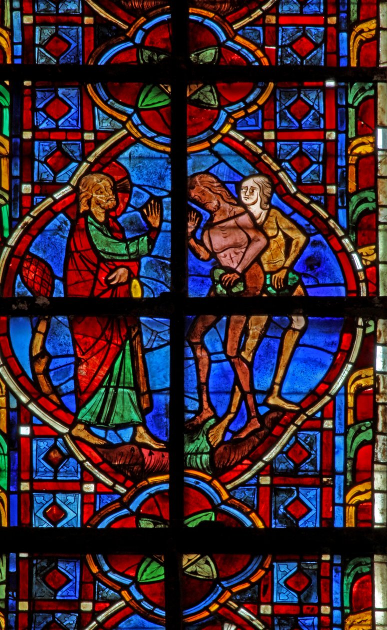 Window depicting Adam and Eve admonished for eating fruit