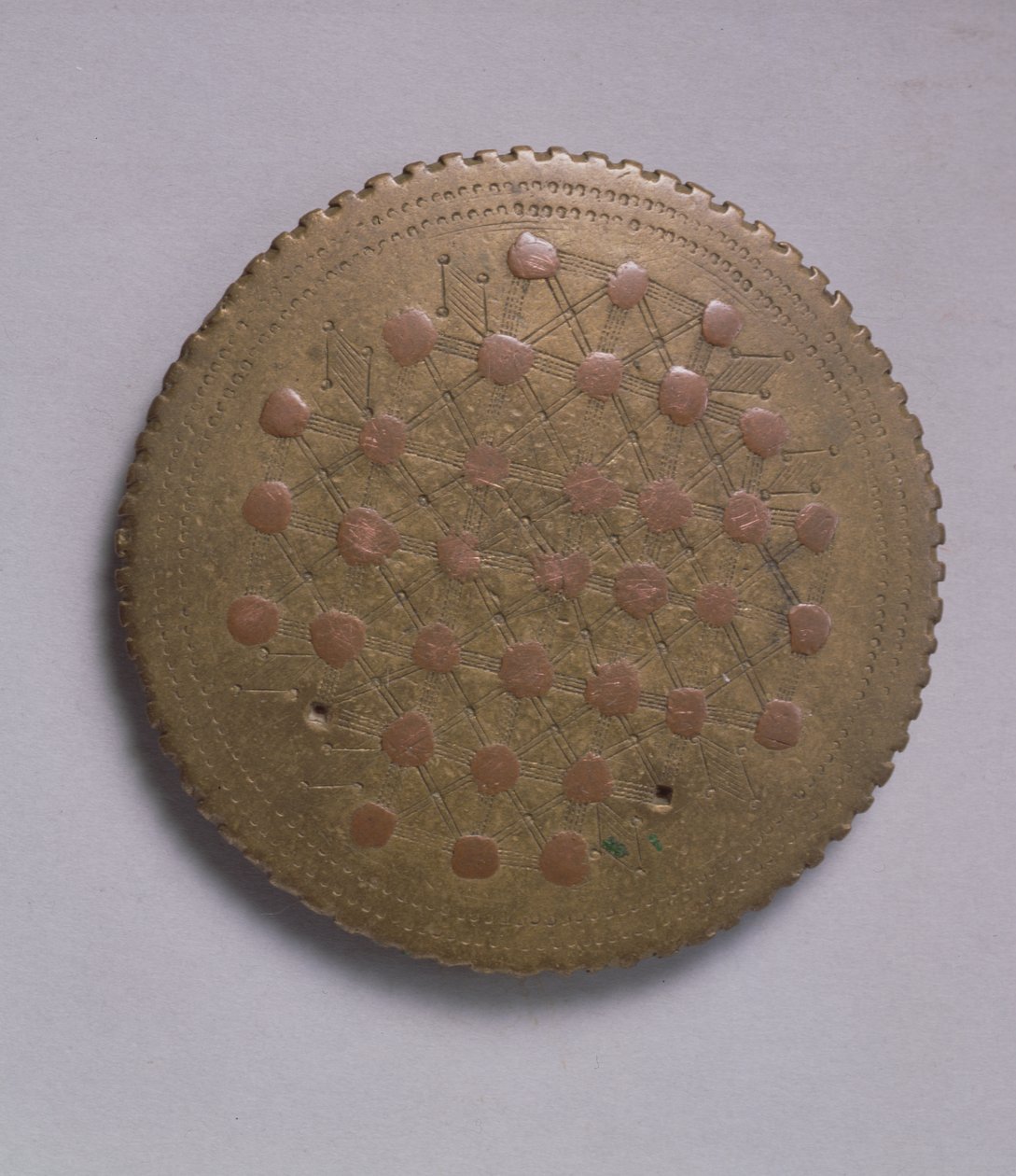 Lens-shaped weight with copper inserts by Ghanaian School