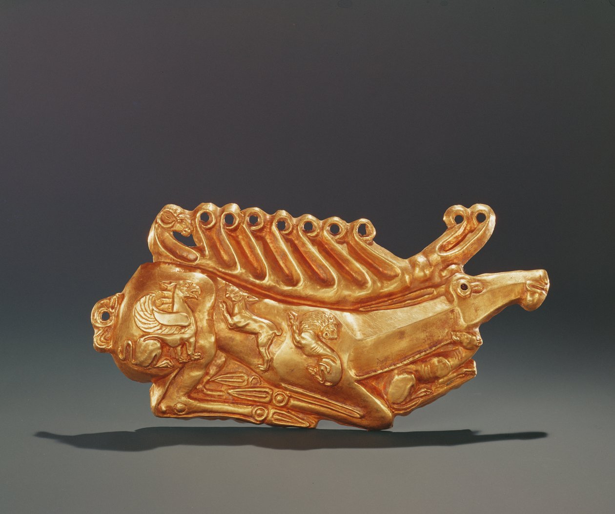 Recumbent stag, decorated on the body with figures of winged griffin ...