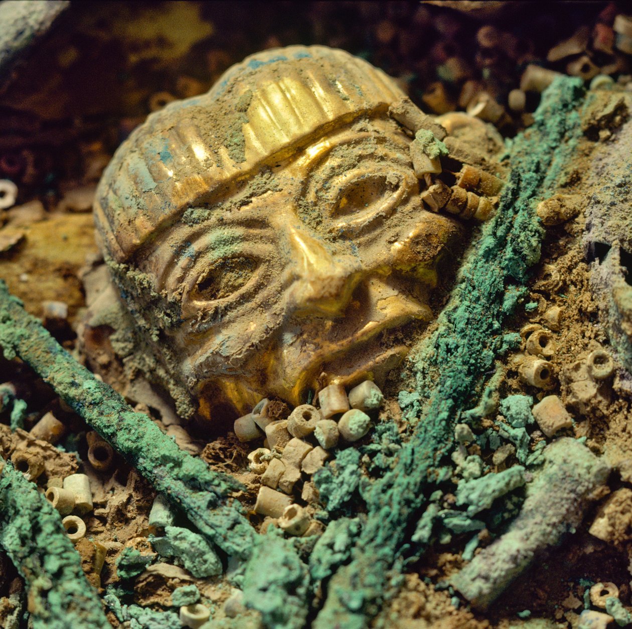 Gold head bead buried in the Moche royal tomb of the Old Lord of Sipan