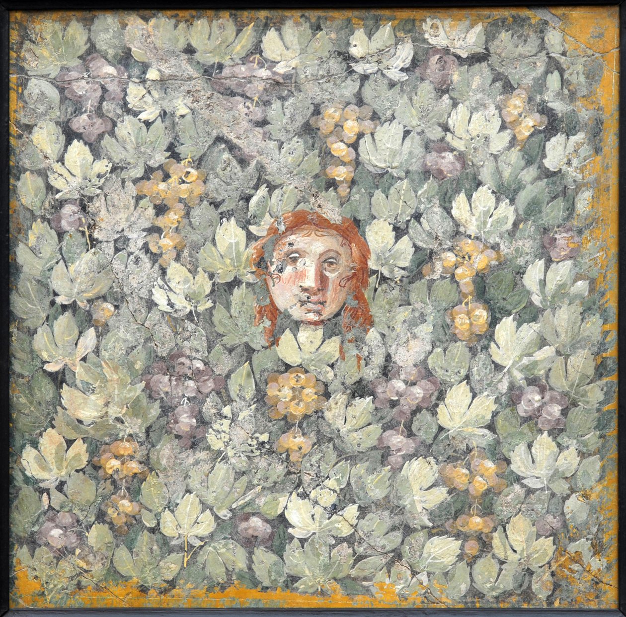 Mask on vine leaves and bunches of grapes, 1st half of 1st century AD