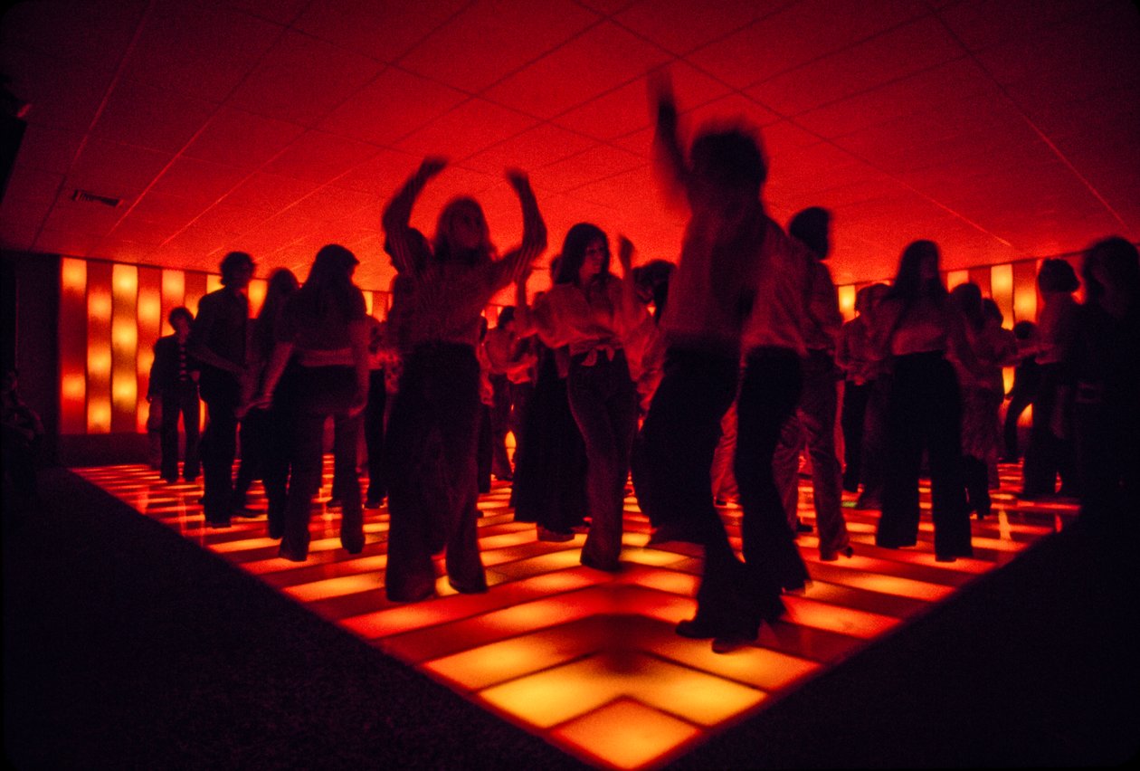Young dancers at a nightclub dancing on an illuminated floor