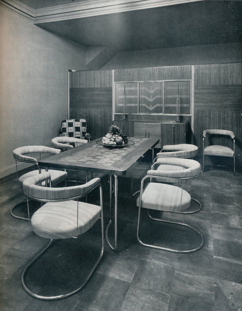A dining-room suite, with table and chairs of steel tube. By Practical ...
