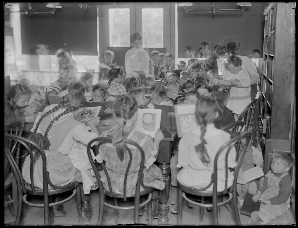 Children reading in the reading room of an unidentified branch of the ...