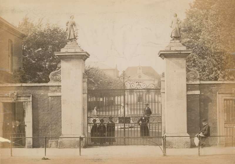 Children Standing Looking Through the School Gate