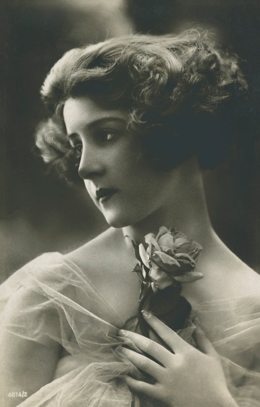 Portrait of a beautiful young woman with a rose